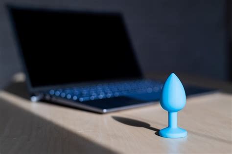 Premium Photo Blue Latex Anal Plug The Laptop On The Table The Concept Of Virtual Sex On The