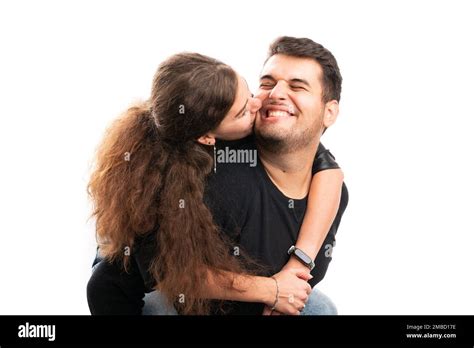 Young Female Model Girlfriend Kissing Man Boyfriend On Cheek Hugging As