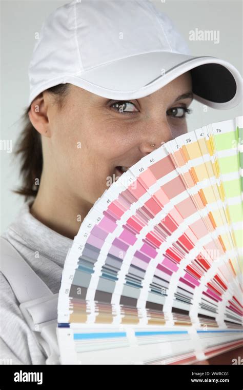 Female Decorator Choosing Color From Swatch Stock Photo Alamy