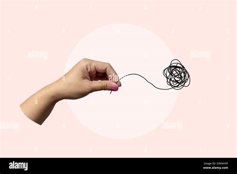 A Hand Holding A Tangled Piece Of String The Image Is Meant To