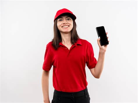 Free Photo Young Delivery Girl Wearing Red Uniform And Cap Showing