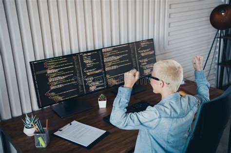 Excited Programmer Celebrating Success While Coding At A Home Office