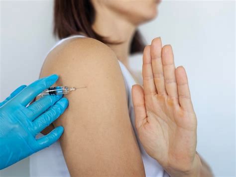 Premium Photo Woman Receiving A Shoulder Injection With Hesitant