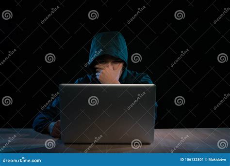 Hacker In A Dark Hoody Sitting In Front Of A Notebook Computer Stock Image Image Of Safety