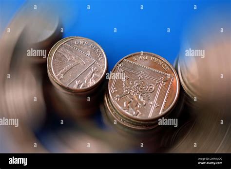 Money Go Round A One Penny And Two Penny Piece In A Rotation Blur On