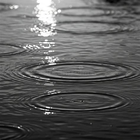 Circular Ripples Spread Across The Surface Of Calm Water Creating Concentric Patterns Stock