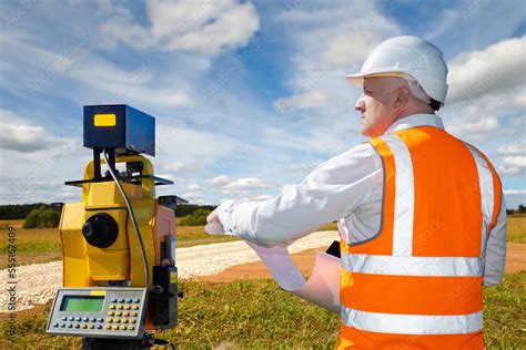 surveyor in field man with geodetic instrument road construction
