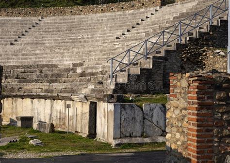 Ancient Stone Amphitheater Featuring Weathered Seating Tiers Historic