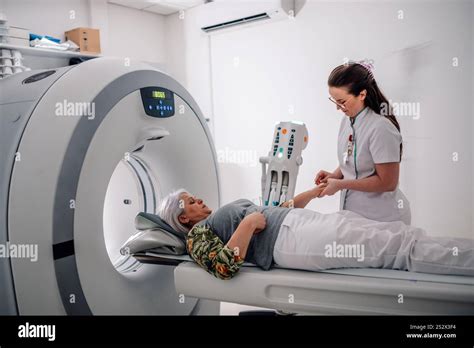A Healthcare Professional Helps A Patient Prepare For A Ct Diagnostic