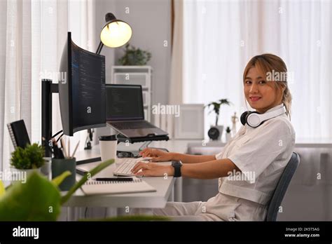 Young Female Developer Working With Coded Data On Computer Screen Developing Programming And