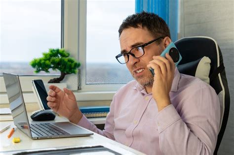 Nice Attractive Worried Guy Tech Expert Geek Nerd Talking On Phone Discussing New Start Up