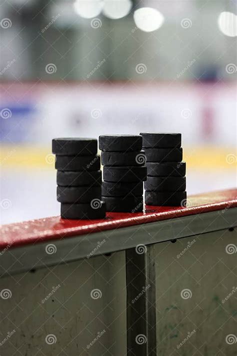 Old Used Ice Hockey Pucks Laying On Board Side Near Bench Stock Image Image Of Puck Game