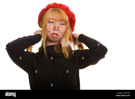 Young Cute Asian Woman Playing With Her Hair And Looking Down Stock