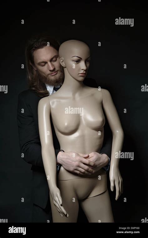 Man Posing With A Female Mannequin Dummy Hugging Her Waist From Behind A Fantasy Romance Sex