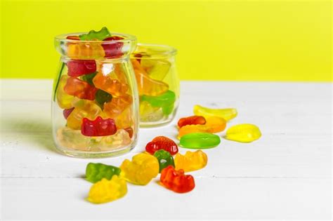 Bottles With Sweet Candies On Table Premium Photo