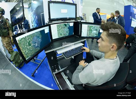 Young Man Sitting In Front Of Monitors And Working With Military Computer Assisted Dispatch