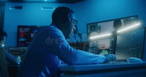 African American Flight Control Employee Monitors Space Mission Stock