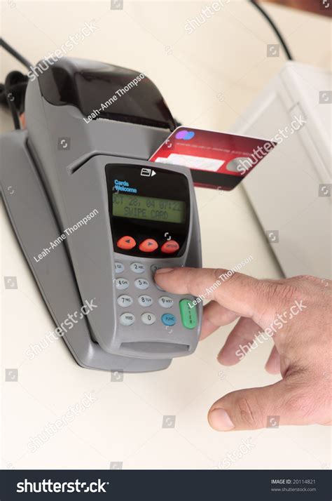 A Retailer Salesman Or Customer Using An Eft Pos Machine To Make A