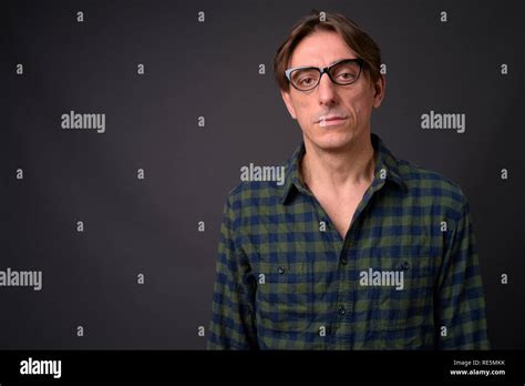 Mature Handsome Italian Man Against Gray Background Stock Photo Alamy