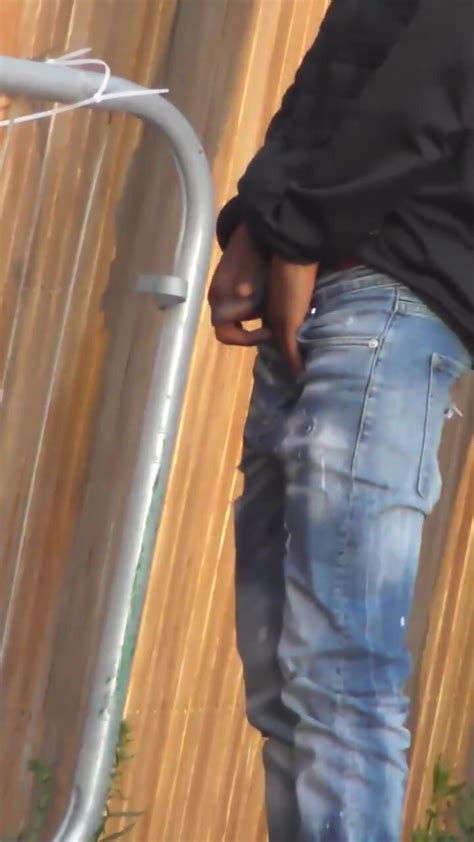Pissing Guys Pissing Against A Fence
