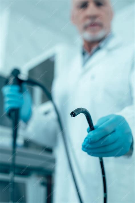 Premium Photo Selective Focus Of An Endoscope In Hand Of A Doctor