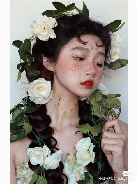 A Woman With Flowers In Her Hair Holding Scissors