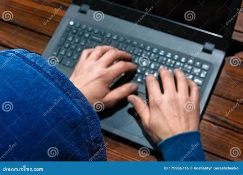Hacker With Computer Man Sitting At A Table In A Hood Stock Photo Image Of Person Hack 175986716