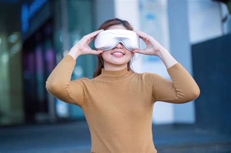 Beautiful Asian Woman With Virtual Reality Outdoors Vr Glasses Equipment At The Department Store