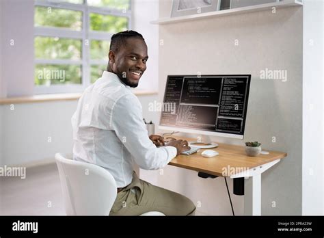 African American Coder Using Computer At Desk Stock Photo Alamy