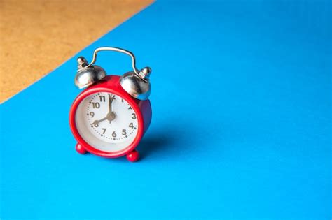 Premium Photo Old Red Alarm Clock On Blue