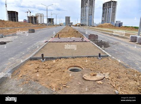 Laying Paving Slabs And Borders At Construction Site Process Of Installing Paving Bricks In The