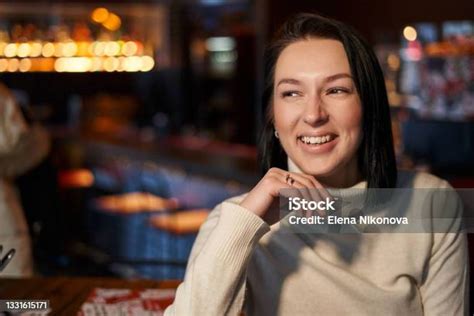 어깨 길이의 어두운 머리를 가진 아름다운 소녀는 카페에 앉아 웃음 치아와 함께 아름다운 미소를 보여주는 배경이 흐릿해졌습니다 30 34세에 대한 스톡 사진 및 기타 이미지