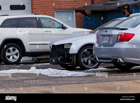 Car With Front End Collision Damage At Auto Body Repair Shop Usa