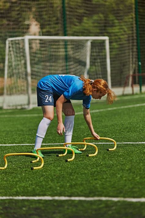 Focused Athletic Training Young Female Athlete In Blue Jersey Training With Agility Drills On