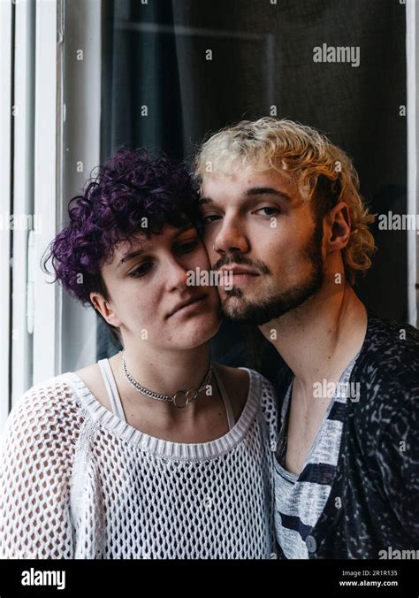 Non Binary Couple At Window Stock Photo Alamy