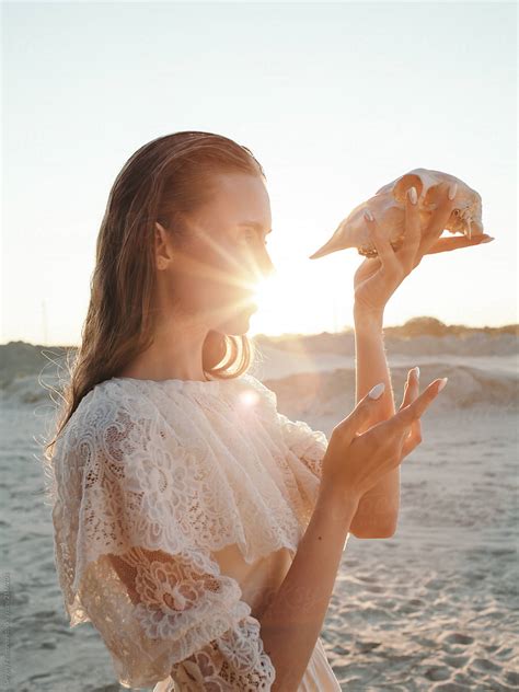Anonymous Woman Looking At Skull By Stocksy Contributor Serge