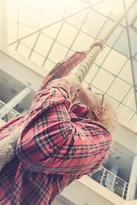 Premium Photo Nerd Guy In A Red Shirt Rises Up The Rope Toned
