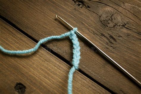 Hook With Knitting On A Wooden Table Air Loops In A Column On A Hook
