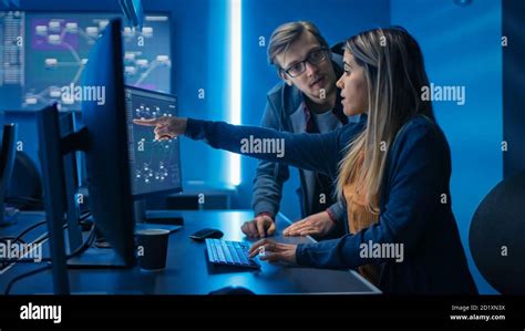 Male And Female Programmers Talking About Work Solving Problems