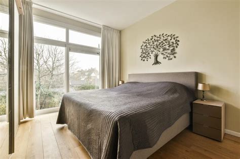 Premium Photo A Bedroom With A Bed And A Tree On The