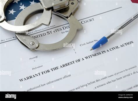 District Court Warrant For The Arrest Of A Witness In A Civil Action Papers With Handcuffs And