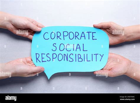People Holding Speech Balloon With Phrase Corporate Social