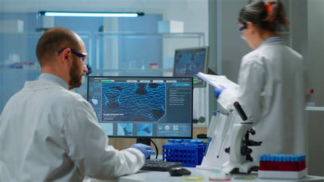 Man Scientist Working To Develop A New Vaccine In Modern Equipped Laboratory Typing At Computer