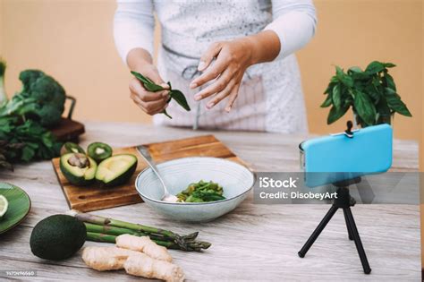 야채와 과일과 녹색 샐러드의 온라인 건강 식품 요리 수업을 스트리밍 젊은 여자 오른손에 초점 요리하기 음식 준비에 대한 스톡