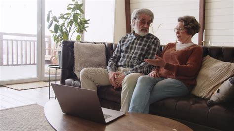 An Elderly Couple Has Difficulty Using A Modern Laptop Happy Mature Couple Using Laptop At Home