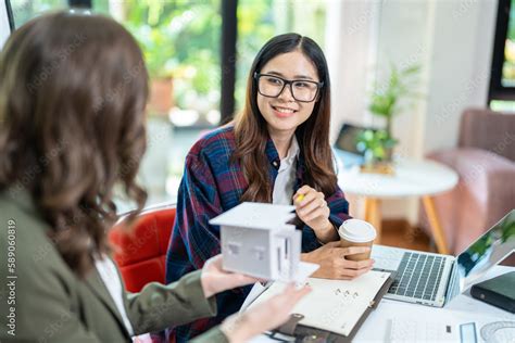 Concept Of Engineering Consulting Two Female Engineers Discussing About Model Of Building
