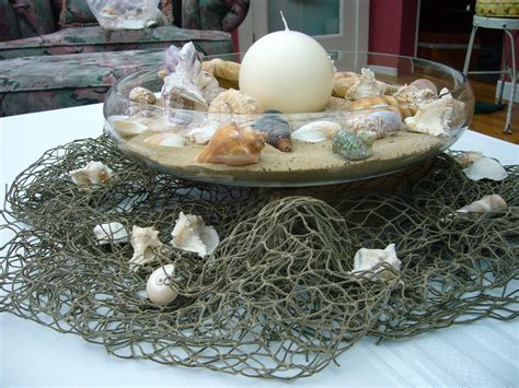 A Candle Is Sitting On Top Of A Bowl Filled With Sea Shells
