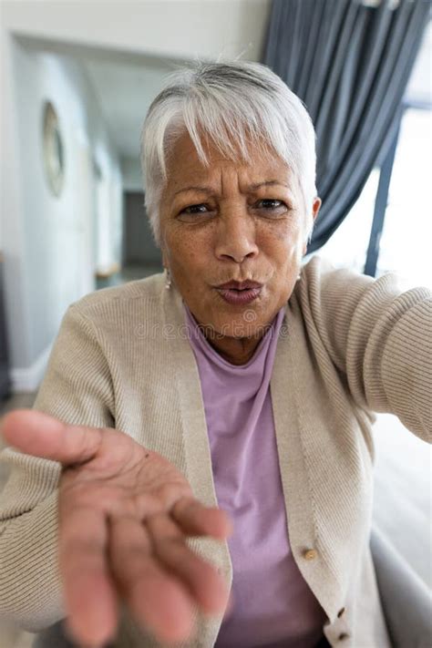 Close Up Portrait Of Biracial Senior Woman Gesturing While Talking Over