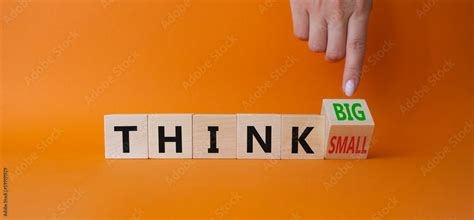 Think Big Vs Small Symbol Businessman Hand Points At Wooden Cubes With