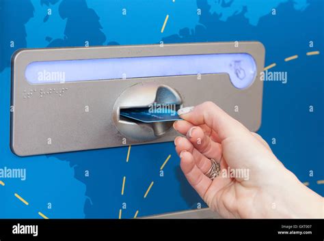 Woman Inserting Her Bank Card Into An ATM Stock Photo Alamy